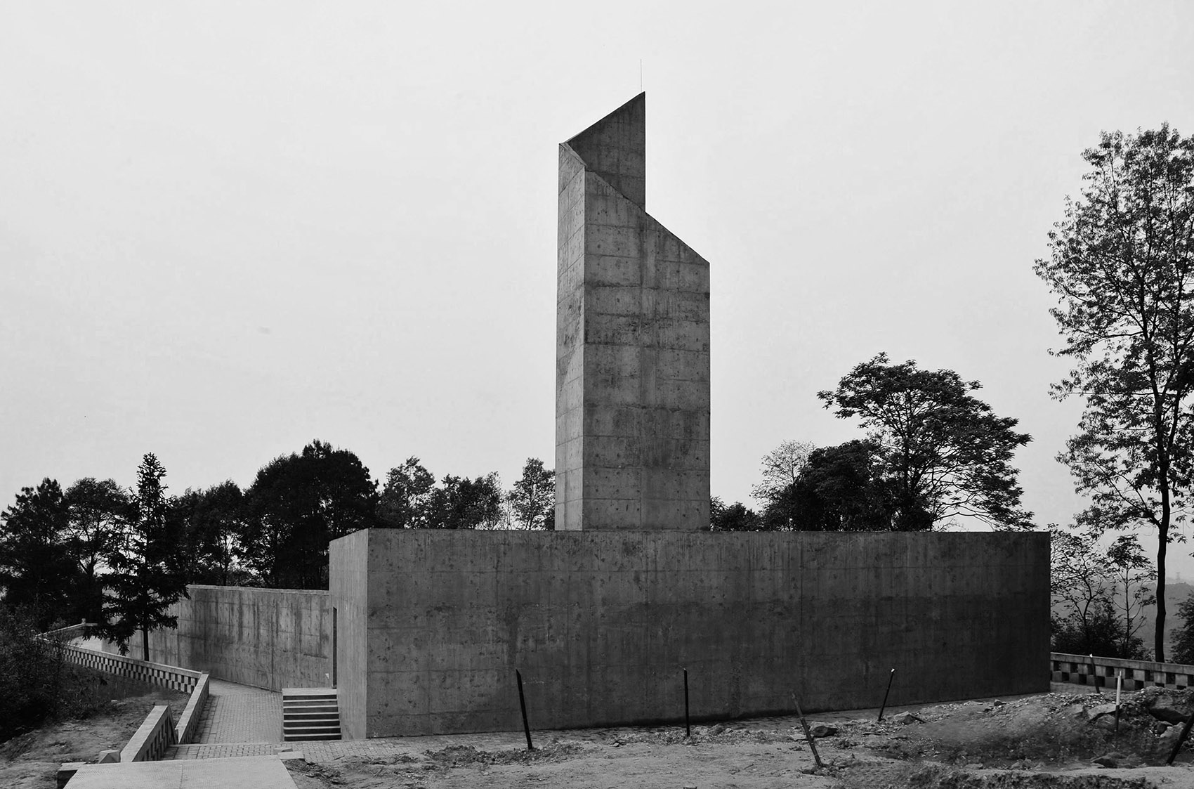 A solitary rough concrete monument rises from destruction, China by ...
