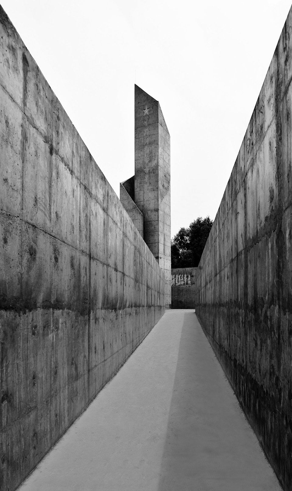 A solitary rough concrete monument rises from destruction, China by ...