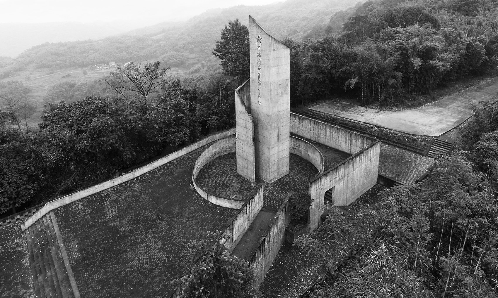 A solitary rough concrete monument rises from destruction, China by ...