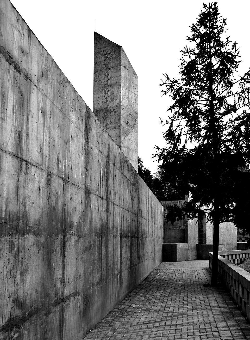 A solitary rough concrete monument rises from destruction, China by ...